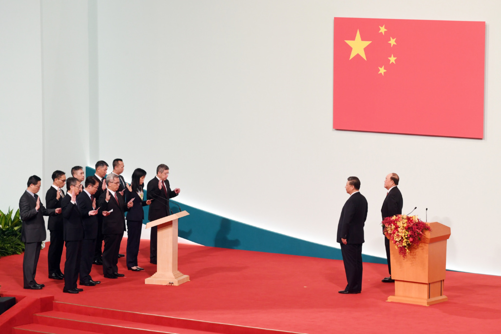 President Xi Jinping administers the oath of office to the principal ...